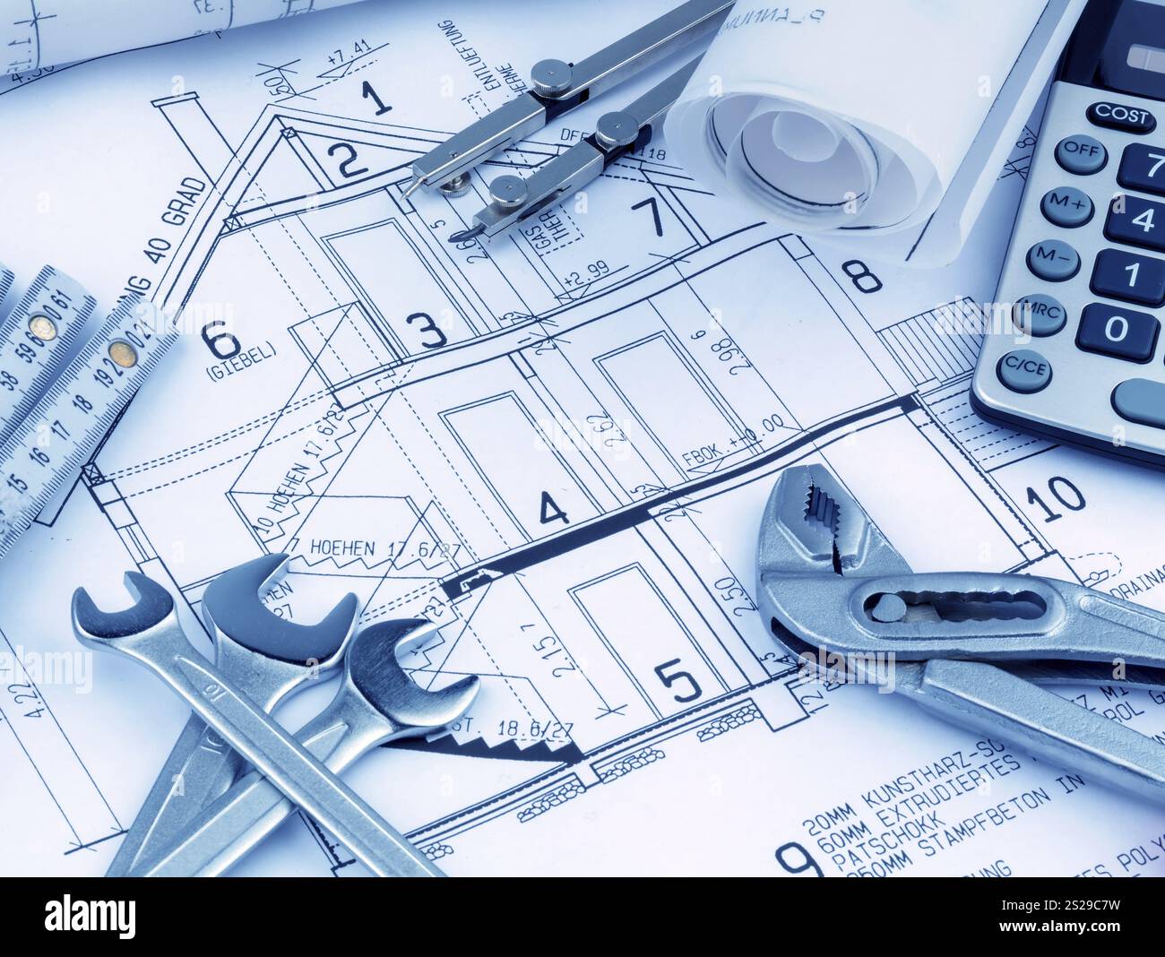 An architect's construction plan with a calculator. Symbolic photo for ...