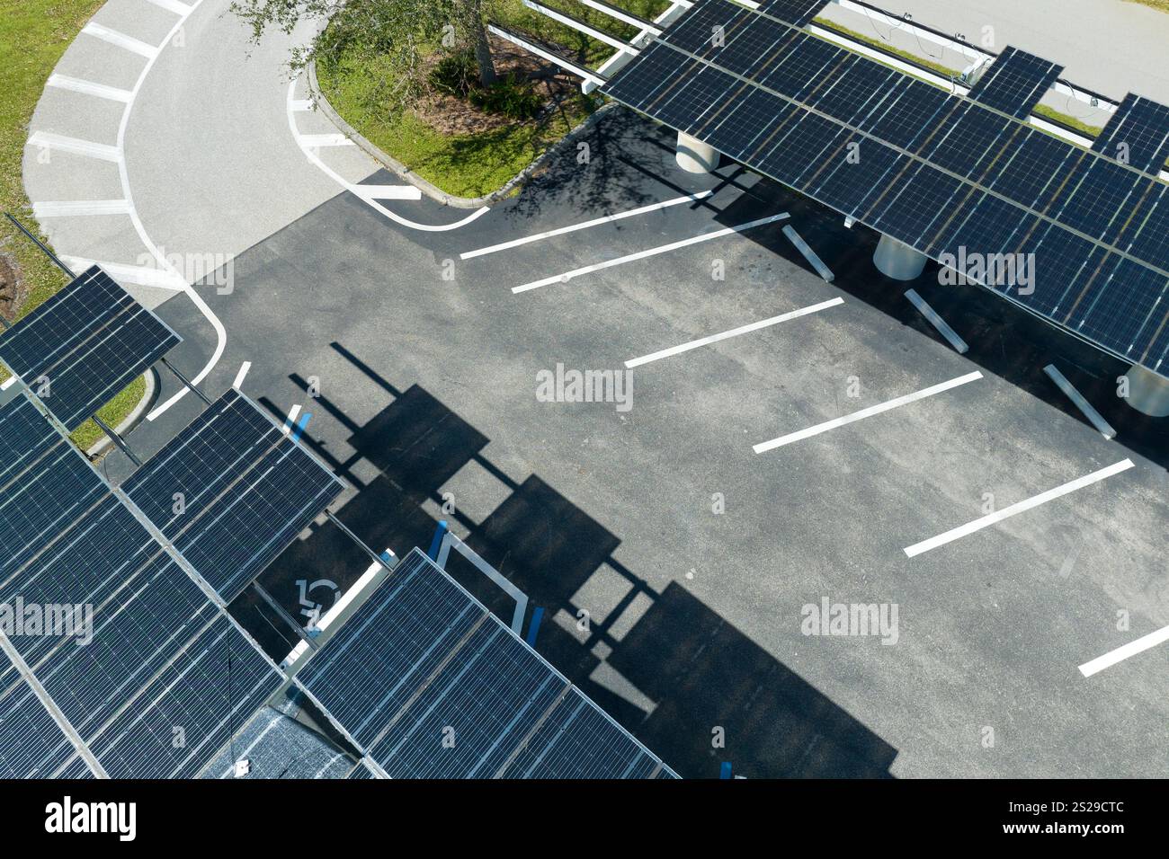 Wind damage to solar panels installed over parking lot canopy shade for parked cars for ...