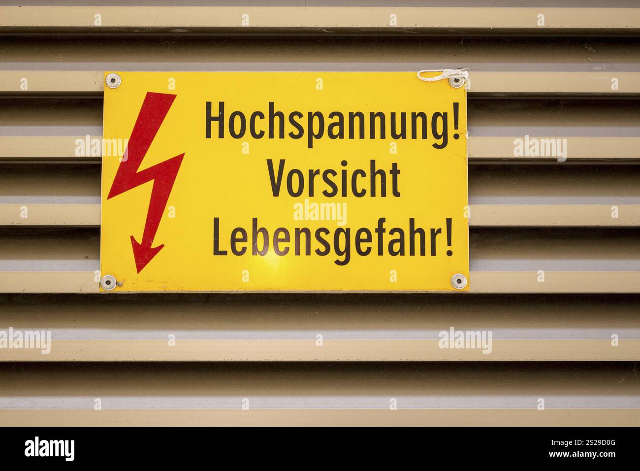 Sign warning of high voltage and current. Austria Stock Photo - Alamy