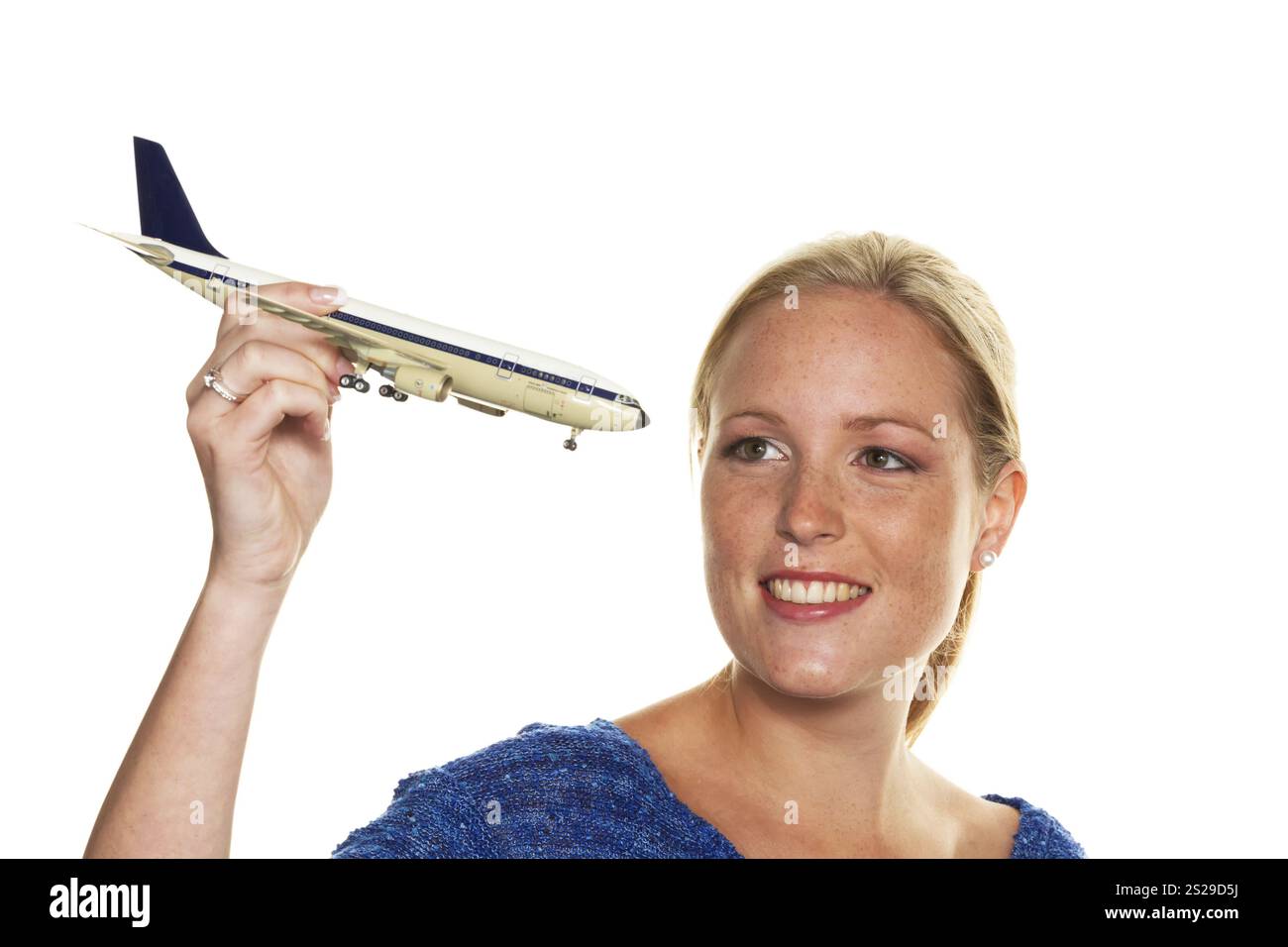 A woman with a model of an aeroplane is looking forward to her next ...