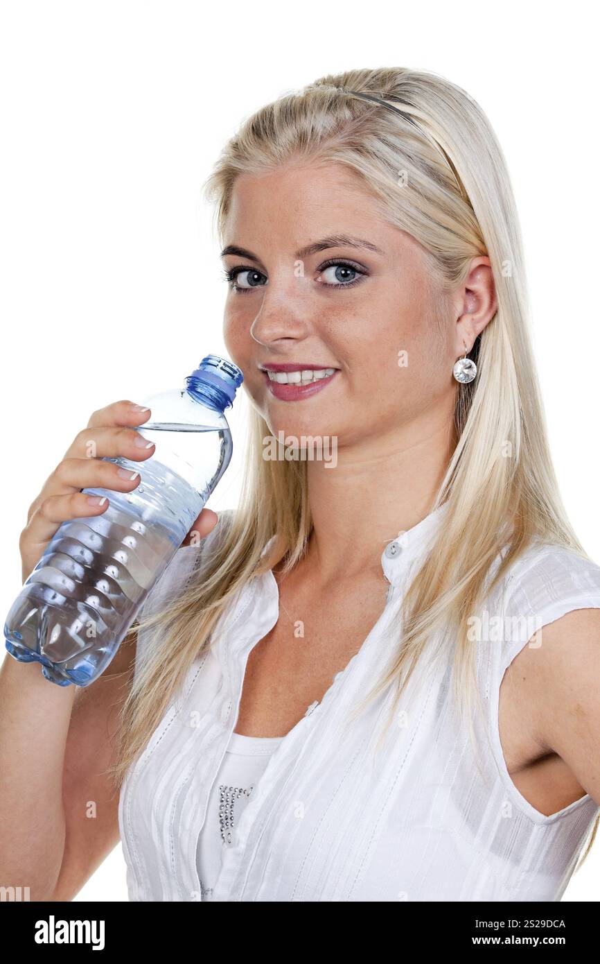 Young woman thirsty and drinking mineral water from a petrol bottle ...