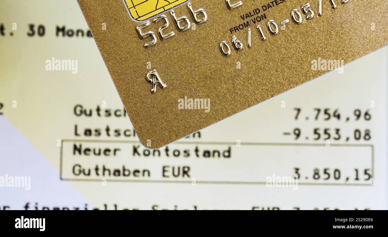 A gold credit card and bank statement... Symbolic photo for cashless ...