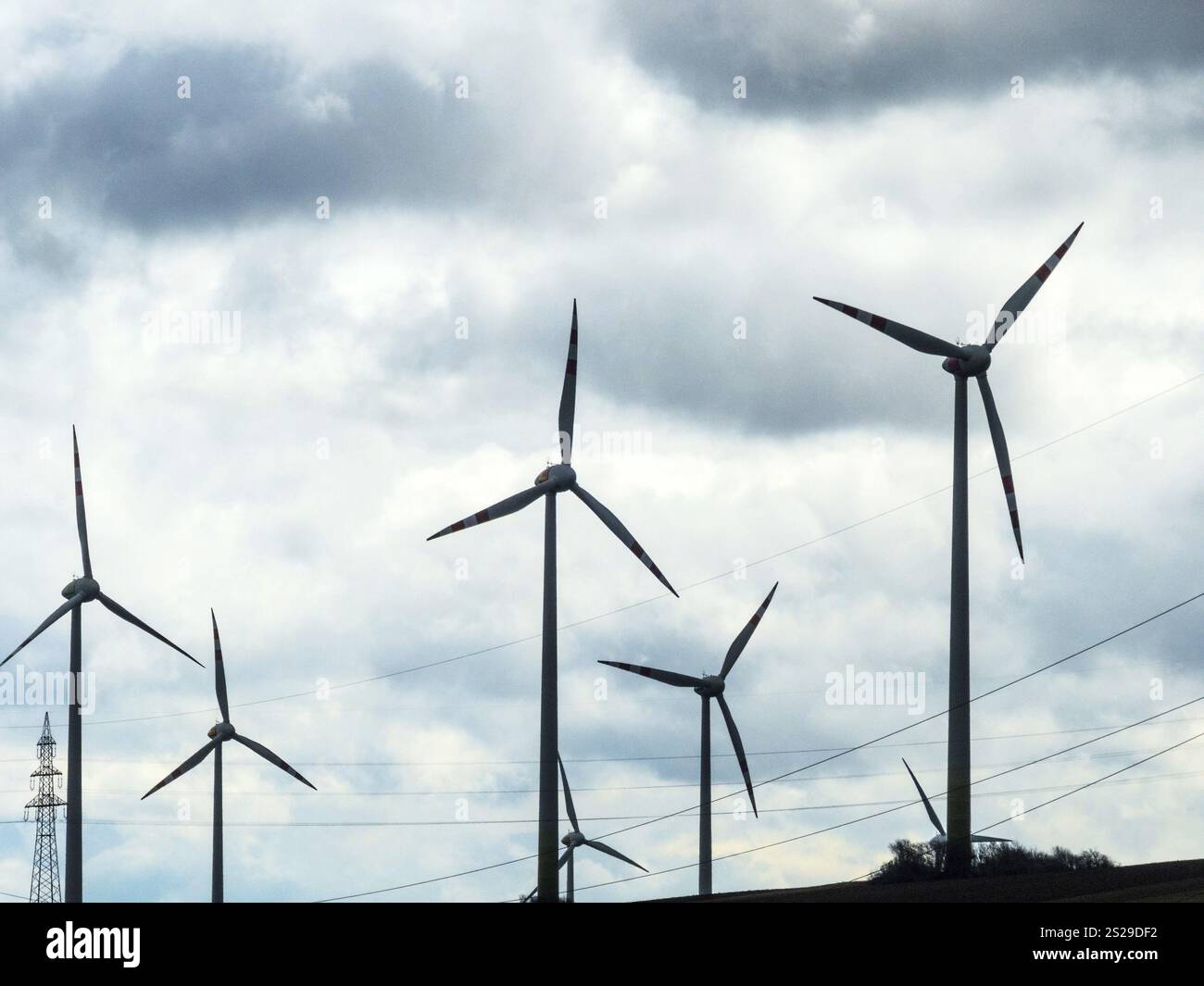 Wind turbines and electricity pylons in a wind farm. Wind power plant ...