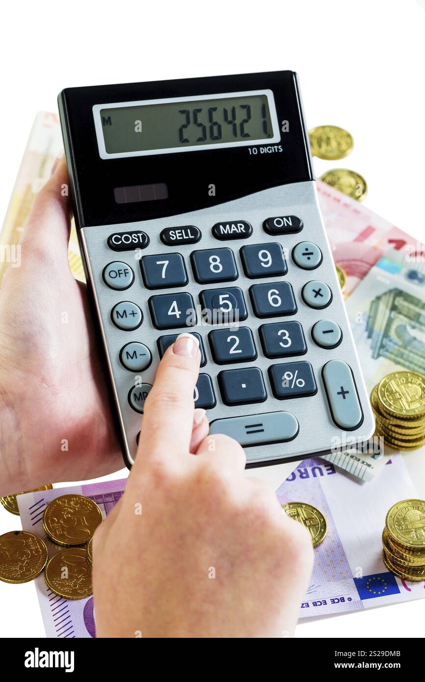 Hand with calculator and banknotes. Symbol photo for turnover, profit ...