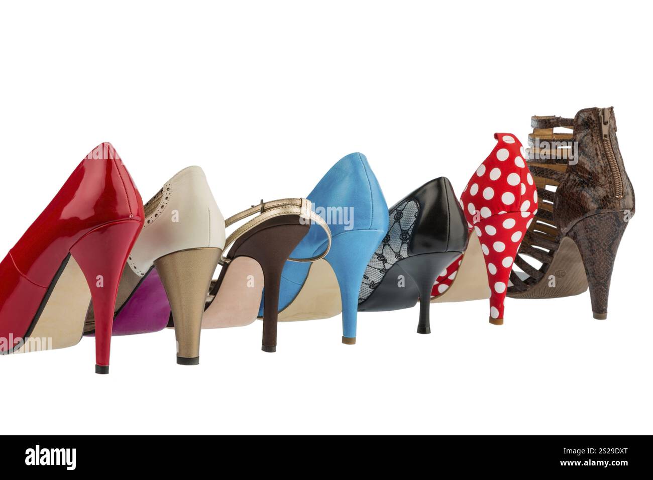 Different coloured shoes with high heels in front of a white background ...