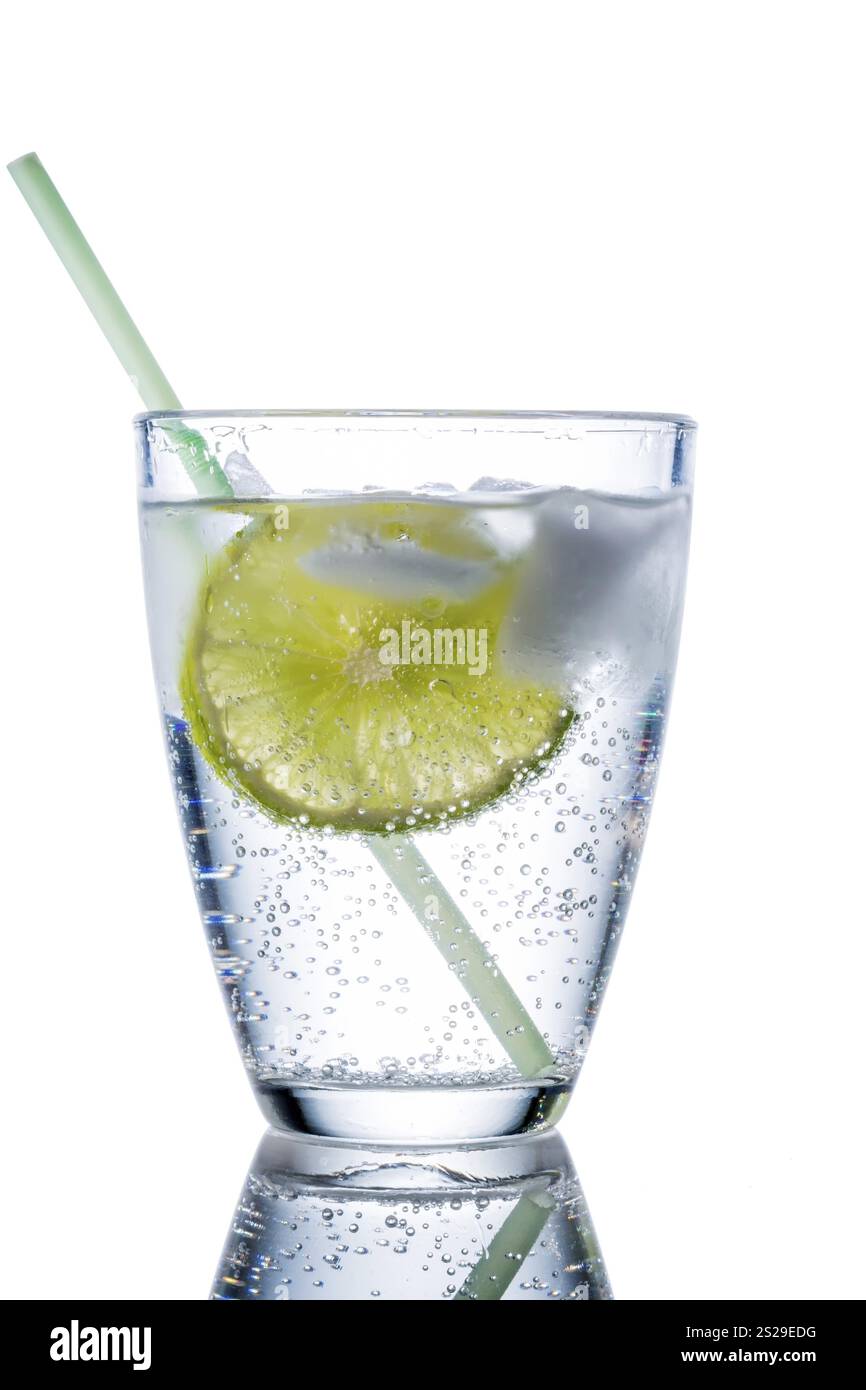 A glass of fresh drinking water and a lime. Mineral water as a thirst quencher. Austria Stock ...