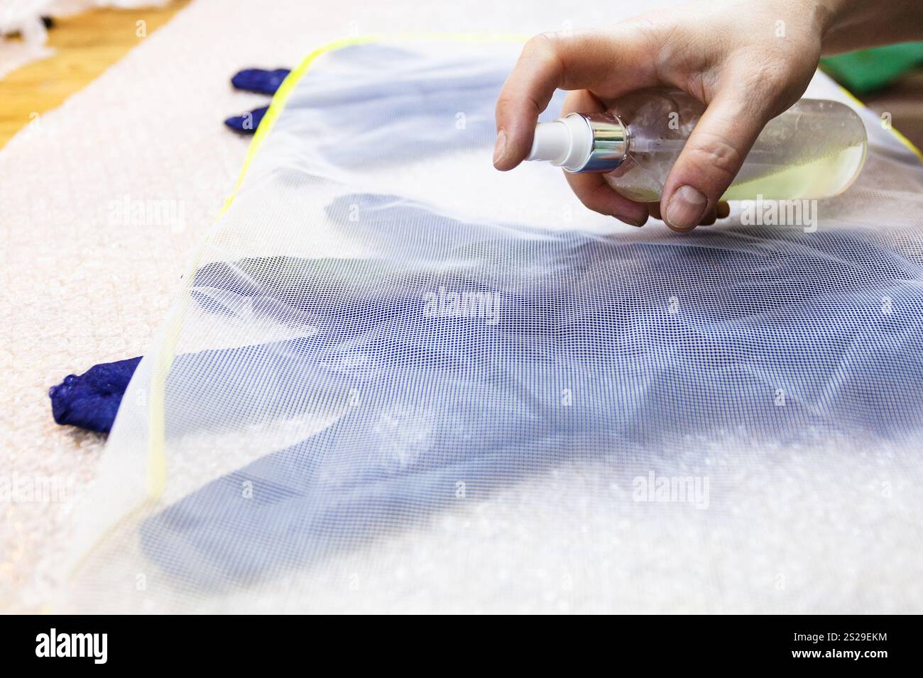 workshop of hand making a fleece gloves from blue Merino sheep wool ...