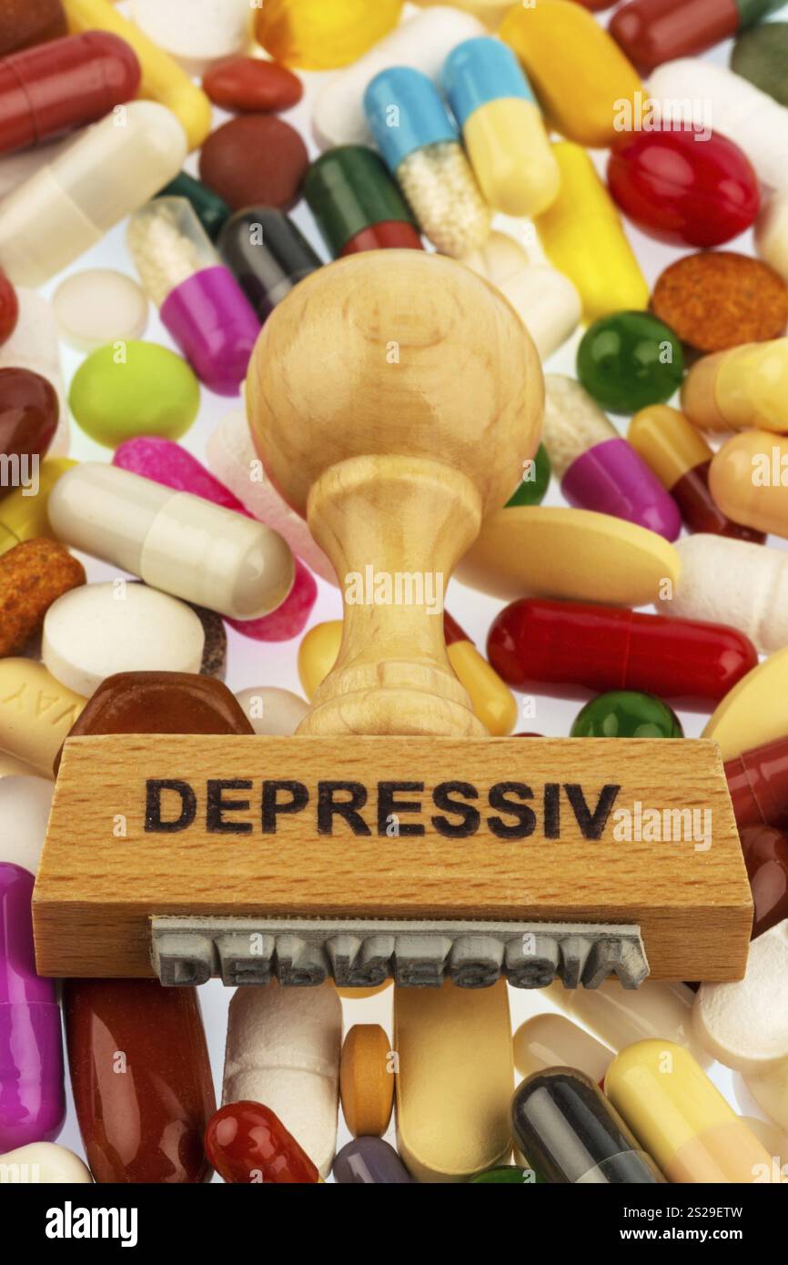 Stamp on colourful tablets, symbolic photo for depression, therapy and ...