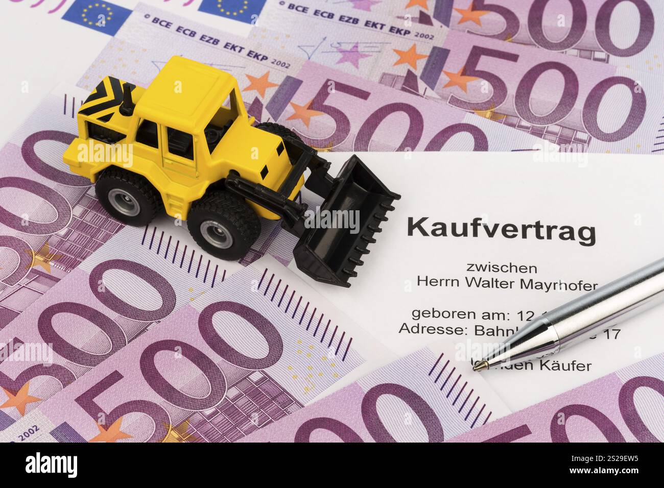 The purchase contract for a new excavator. With euro money and biros ...