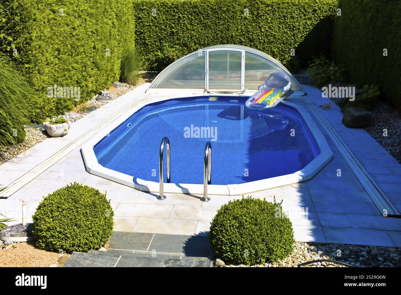 The swimming pool of a detached house invites you to take a dip Stock ...