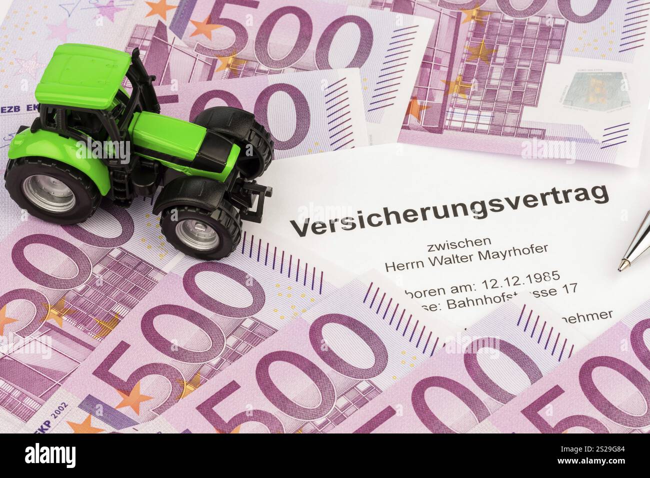 An insurance contract for a new tractor. With euro money and biros ...