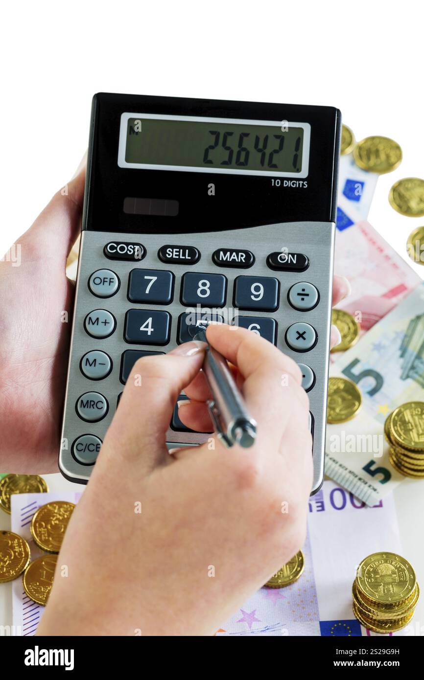 Hand with calculator and banknotes. Symbol photo for turnover, profit ...