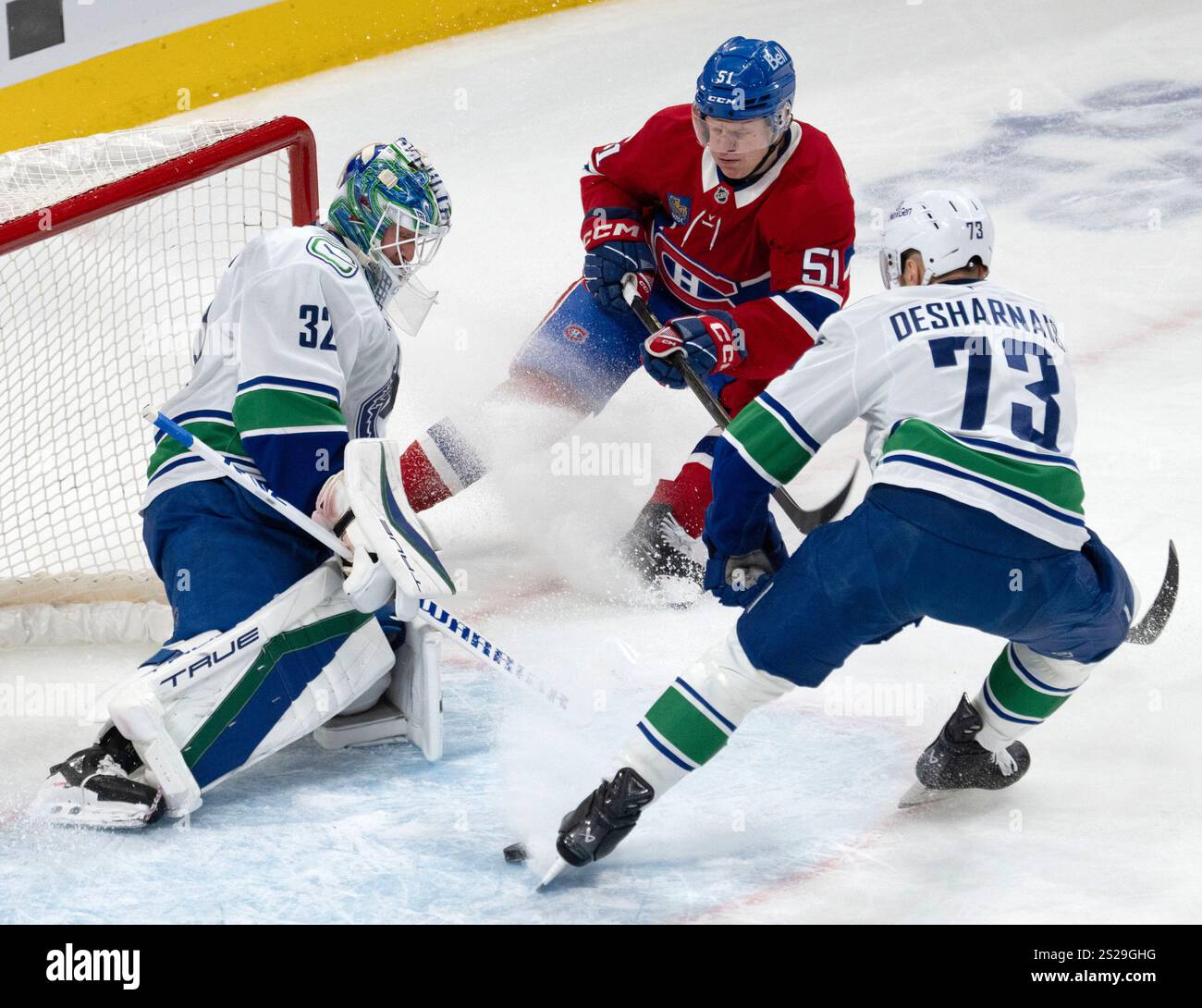 Montreal Canadiens' Emil Heineman (51) is stopped by Vancouver Canucks ...