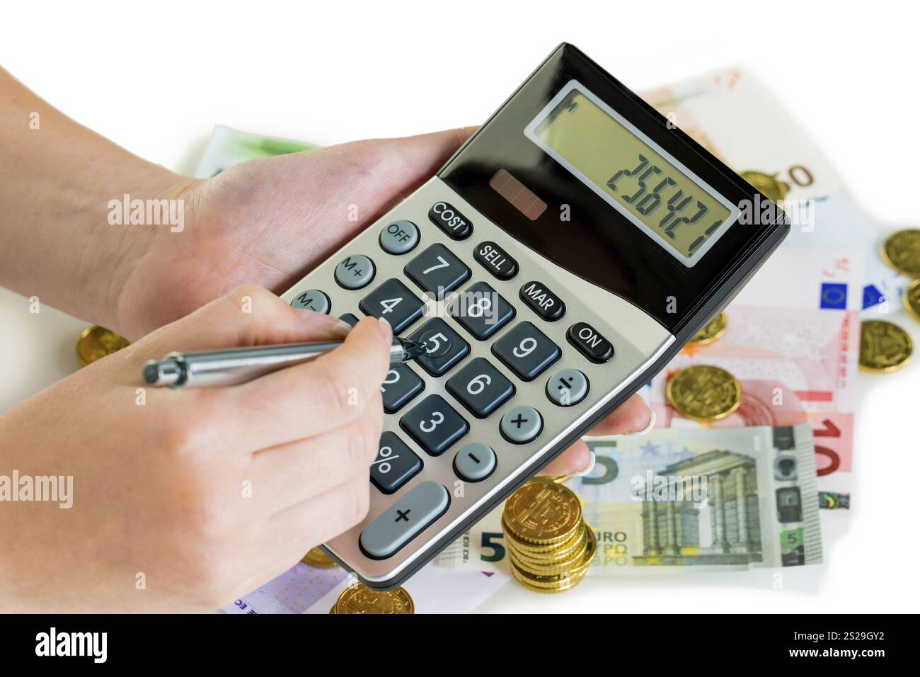 Hand with calculator and banknotes. Symbol photo for turnover, profit ...