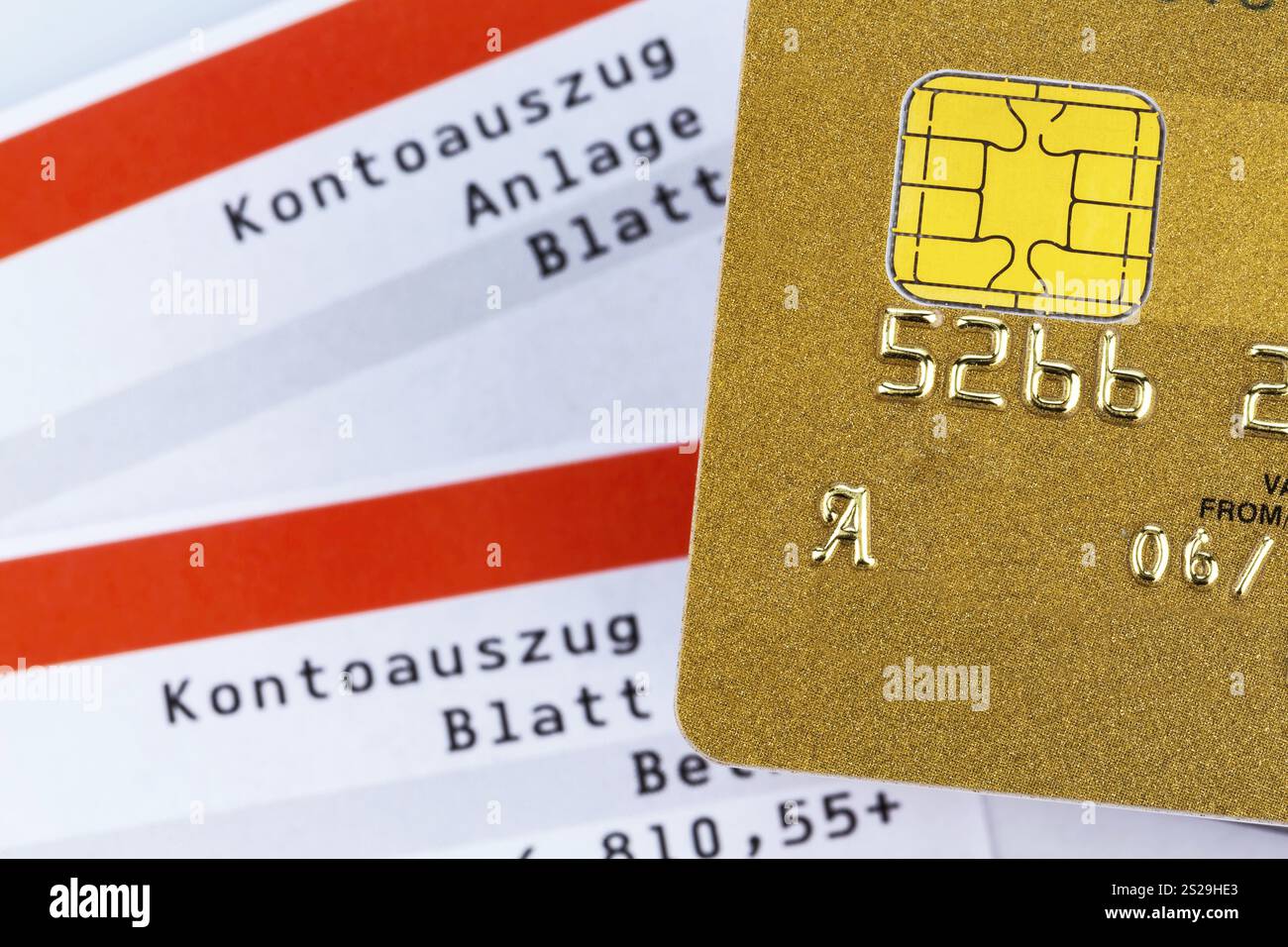 A gold credit card and bank statement... Symbolic photo for cashless ...