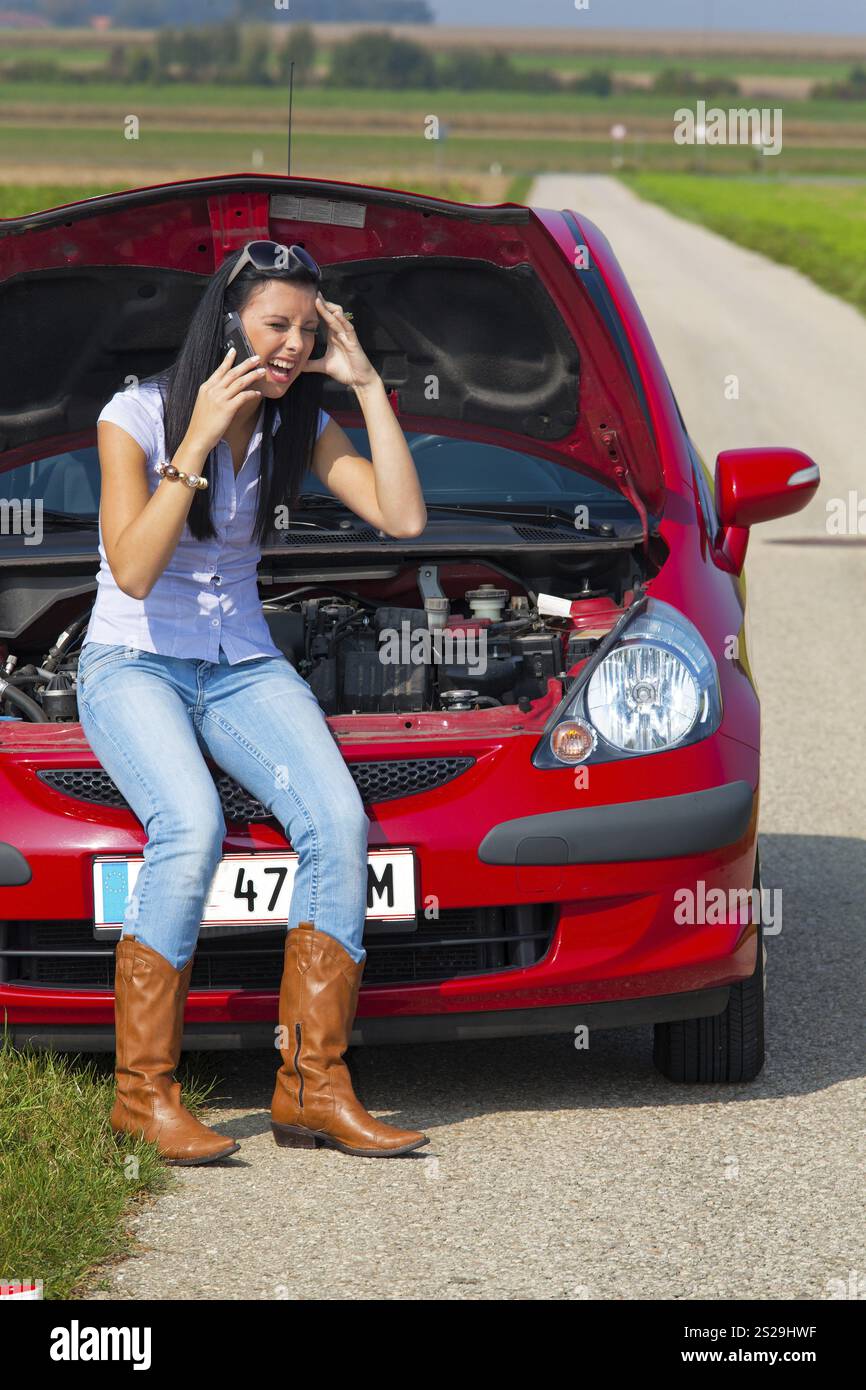 Young woman's car breaks down. Engine failure Stock Photo - Alamy
