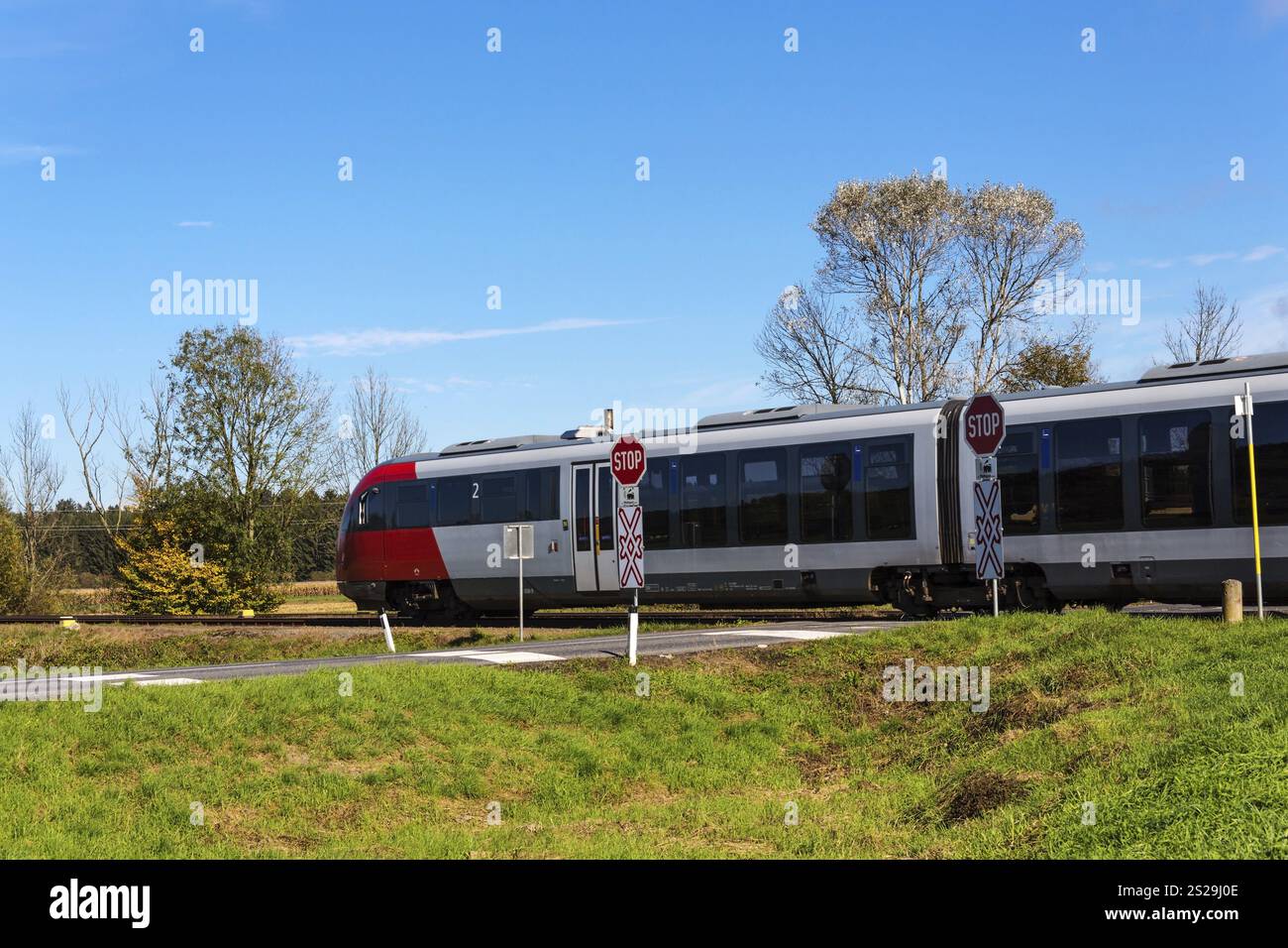 A railway level crossing without barriers. Secured only by traffic ...
