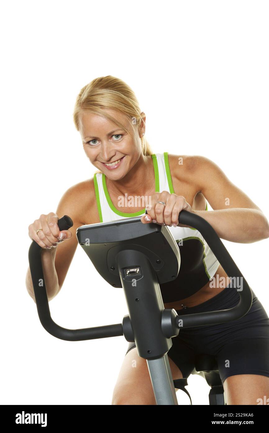 A woman trains on a cycle ergometer in the gym Austria Stock Photo - Alamy