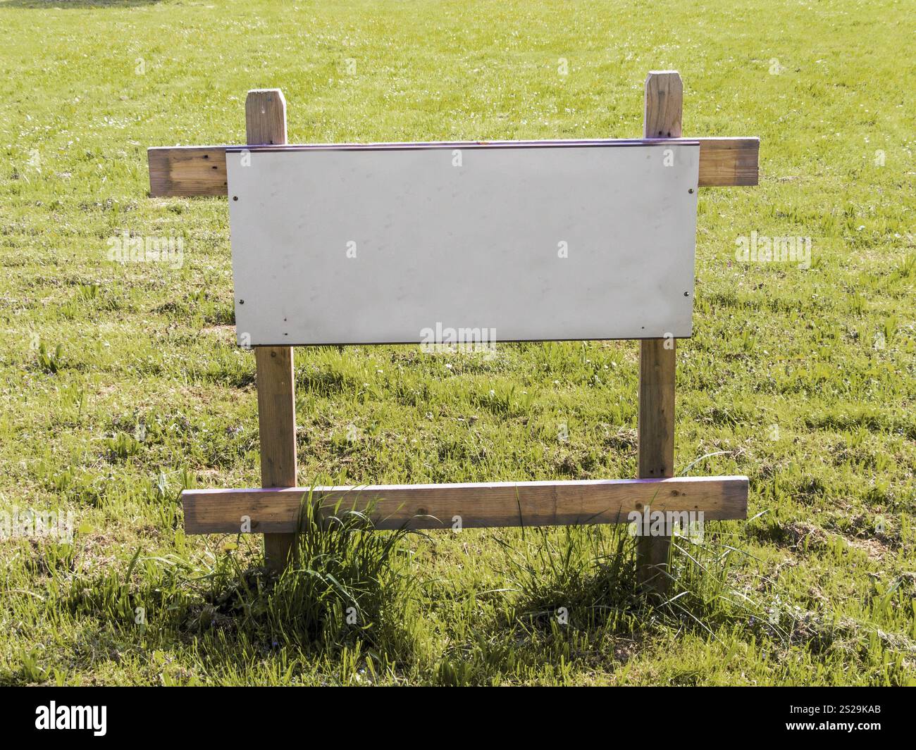 On a meadow is a sign for a building plot for a house for sale ...