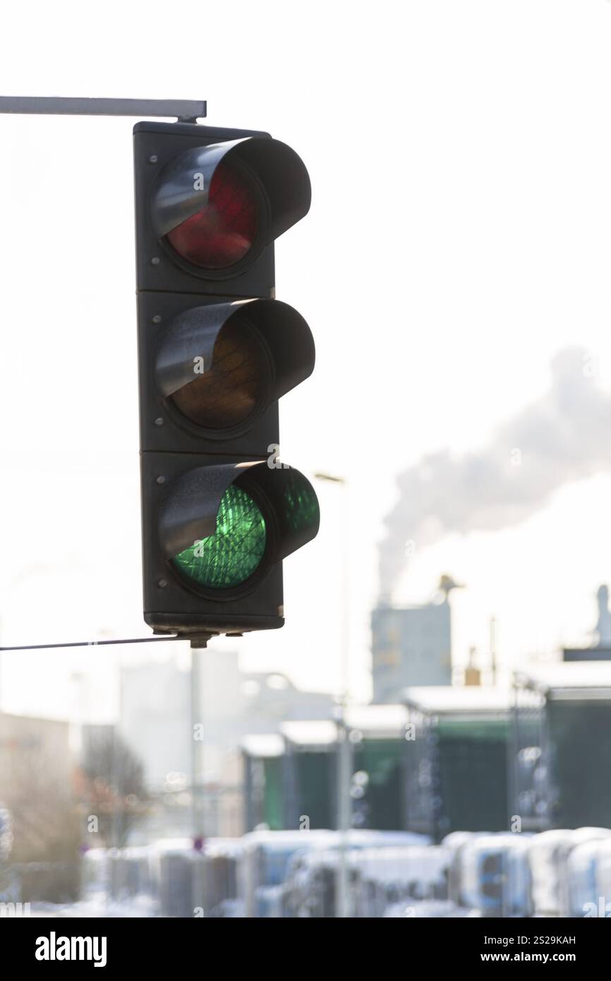 Industrial plant chimney and green traffic light. Symbolic photo for ...