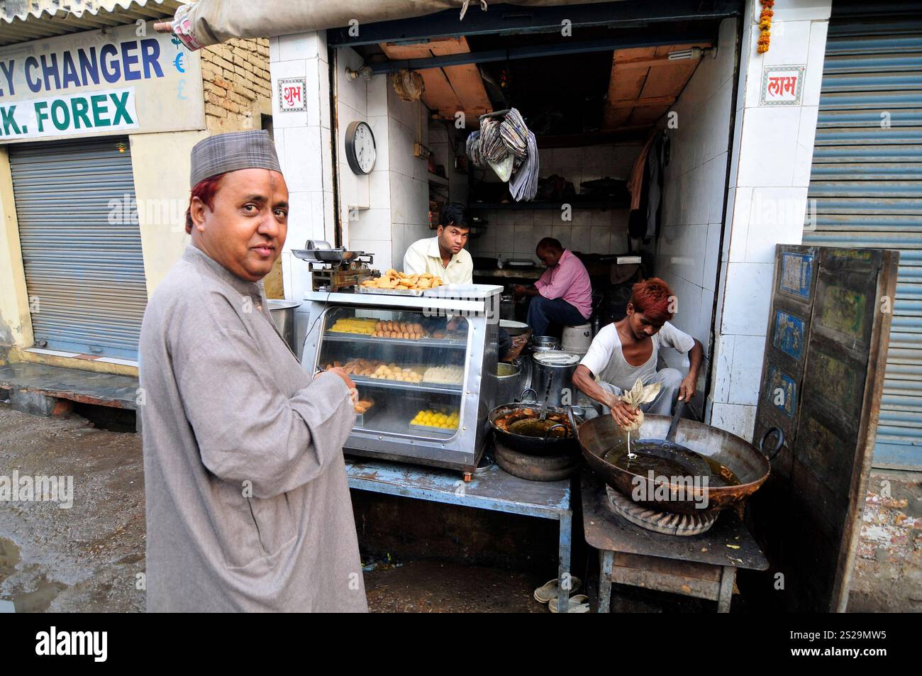 Preparing Jalebi sweets at a small sweet shop in the old city of Agra ...