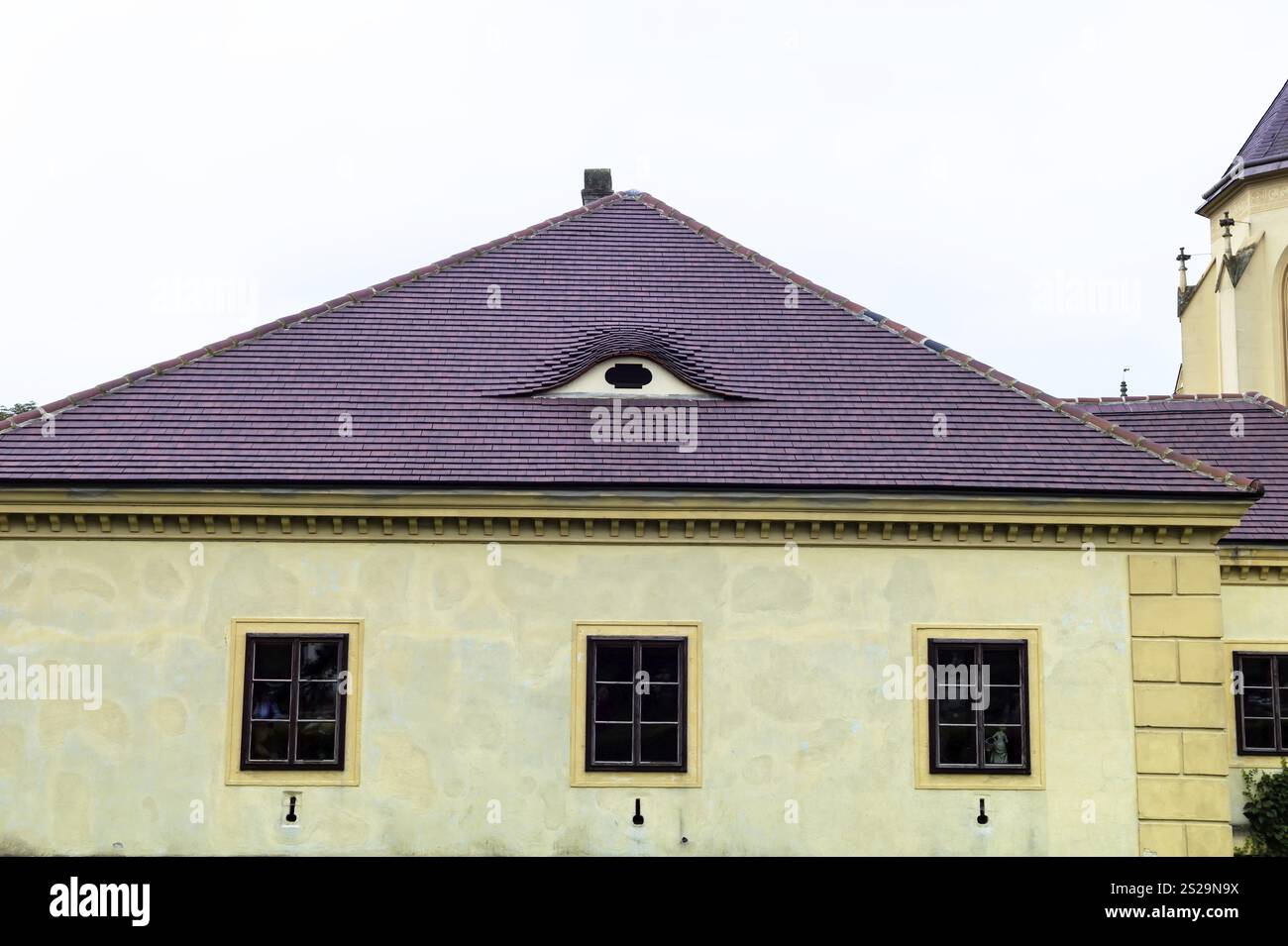 The roof of a house with a small window Stock Photo - Alamy