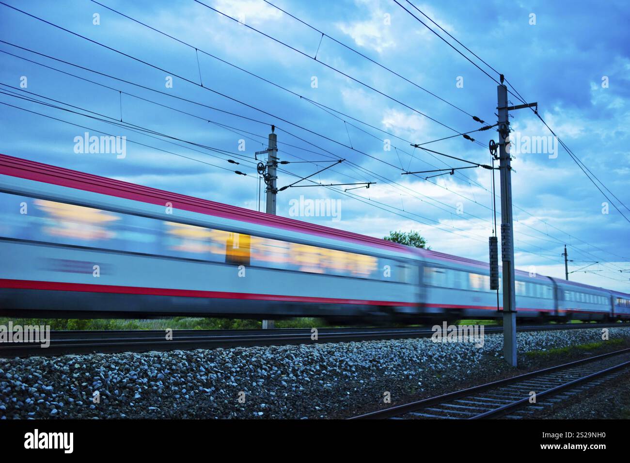 A passenger train travelling through the night. Night train with OeBB ...