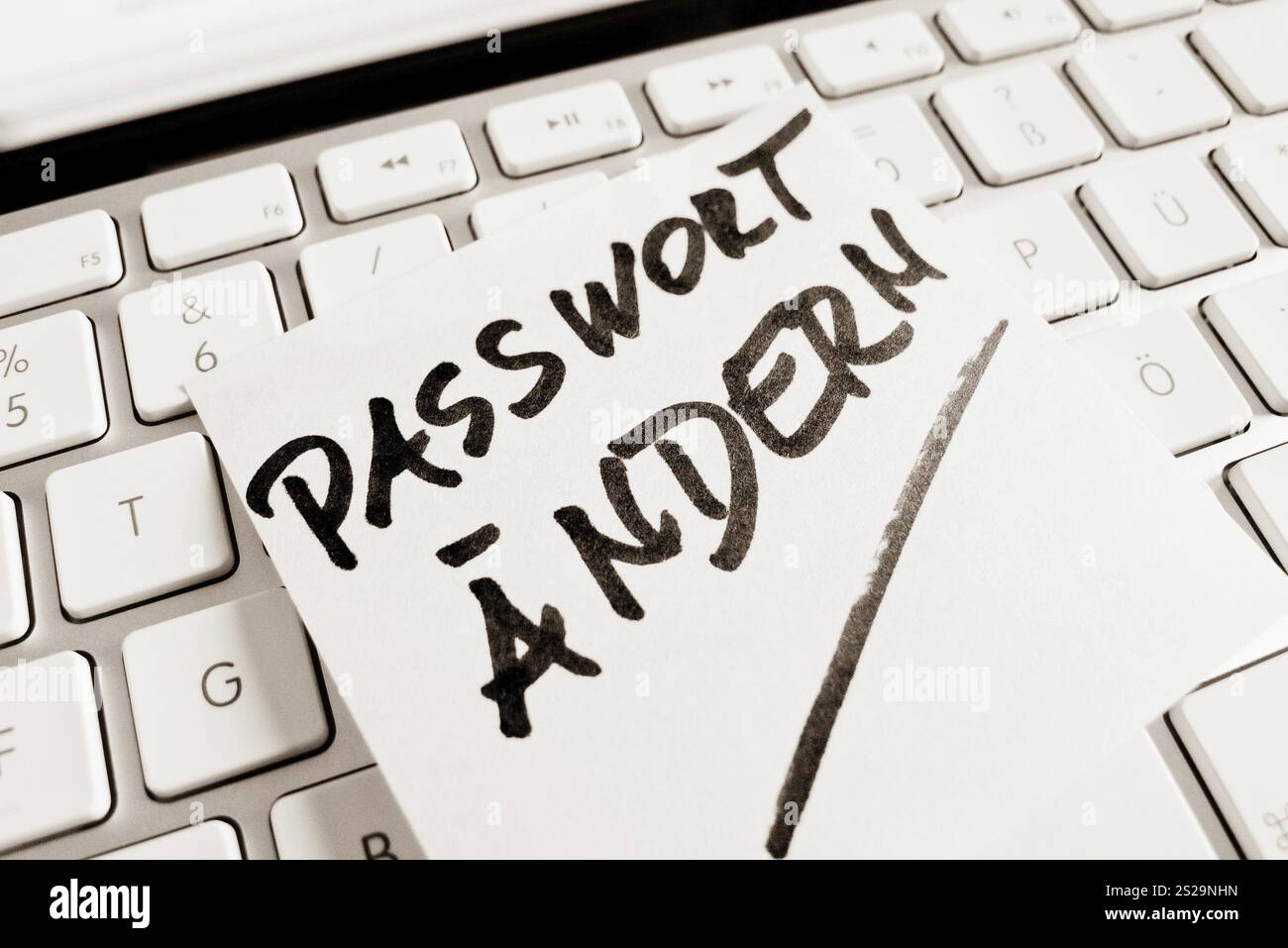 A note on the keyboard of a computer as a reminder: Change password ...