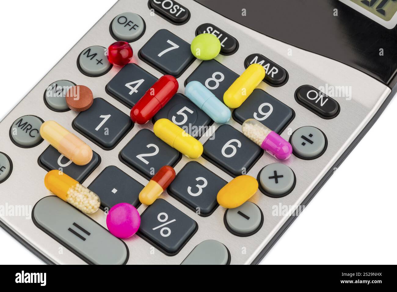 Tablets lying on a calculator. Symbol photo for costs in the medical ...