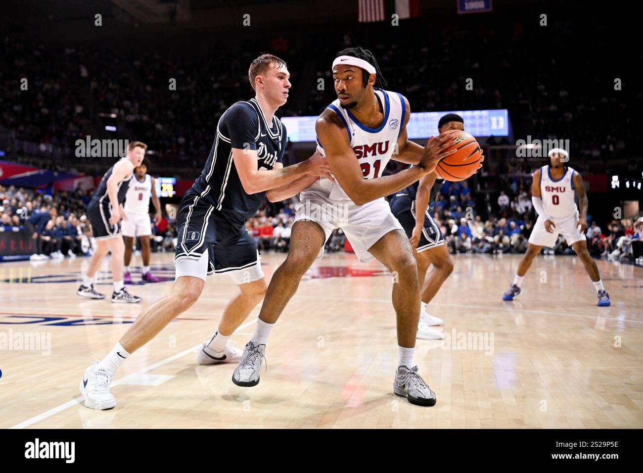 SMU forward Yohan Traore (right) looks to move the ball past Duke guard ...
