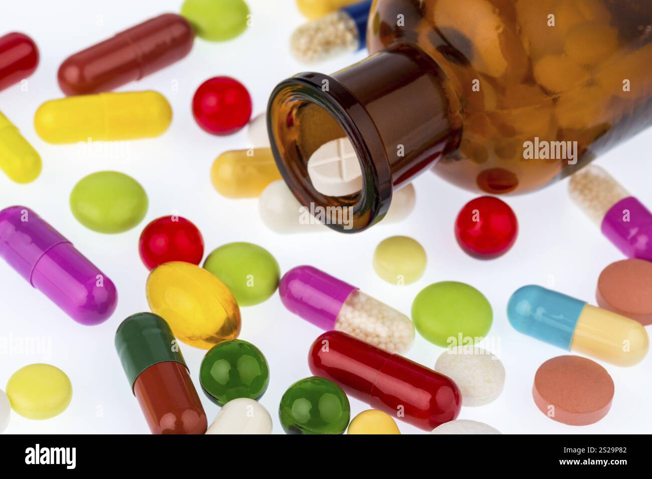 Many tablets with a glass container. Symbolic photo for addiction and ...