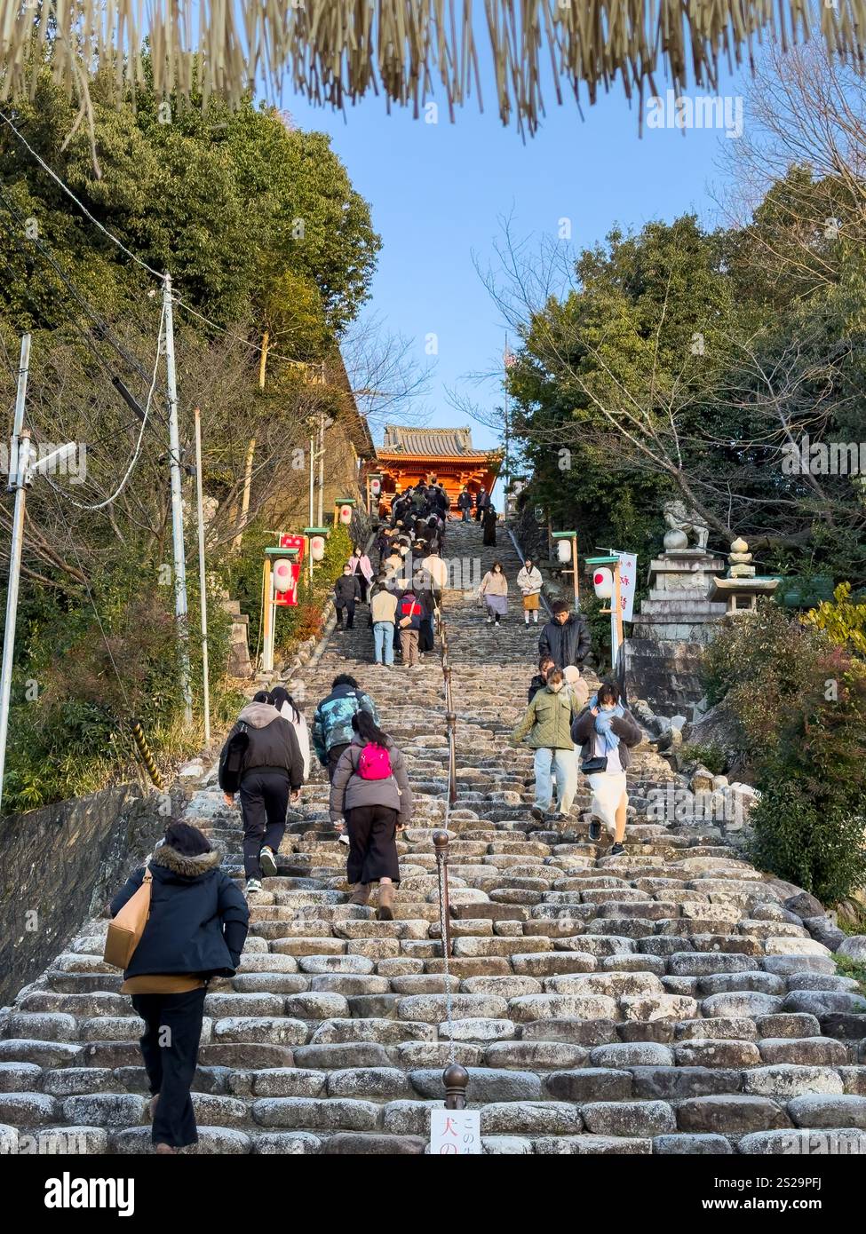 People climb the many steps it Isaniwa Shrine, Dogo, Matsuyama, Japan ...