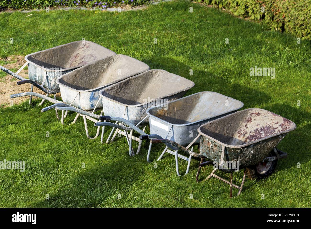 Discard chests stand side by side on a construction site. Tidy building ...