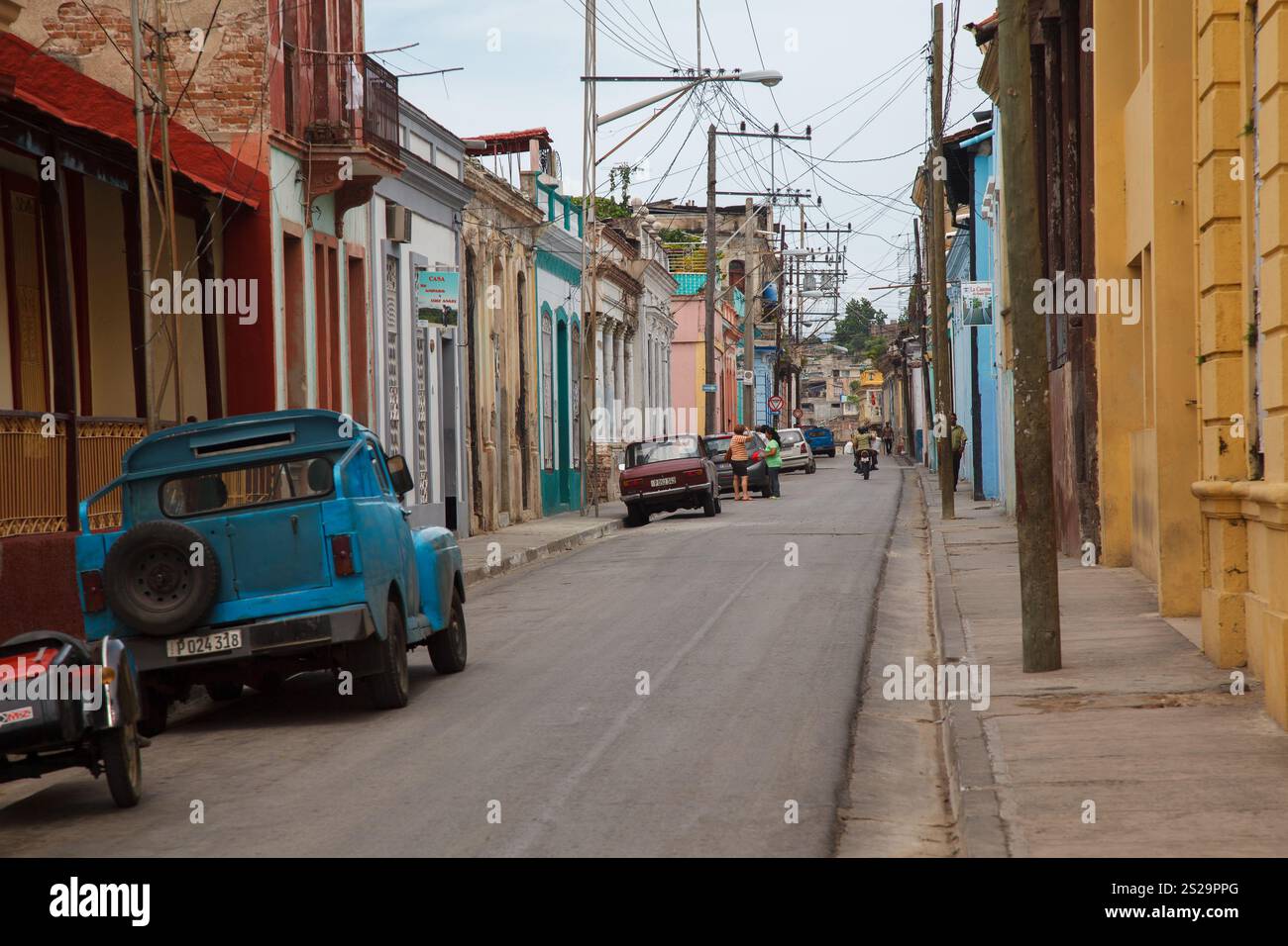 A Typical tradiional colonial houses in a street of Santiago de Cuba ...
