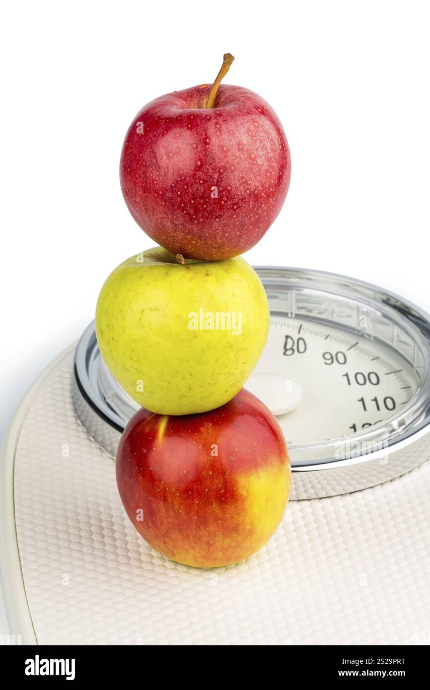 Several apples on a set of scales for people. Symbolic photo for diet ...