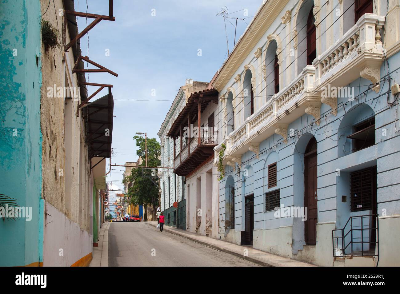 The typical tradiional colonial houses in a street of Santiago de Cuba ...