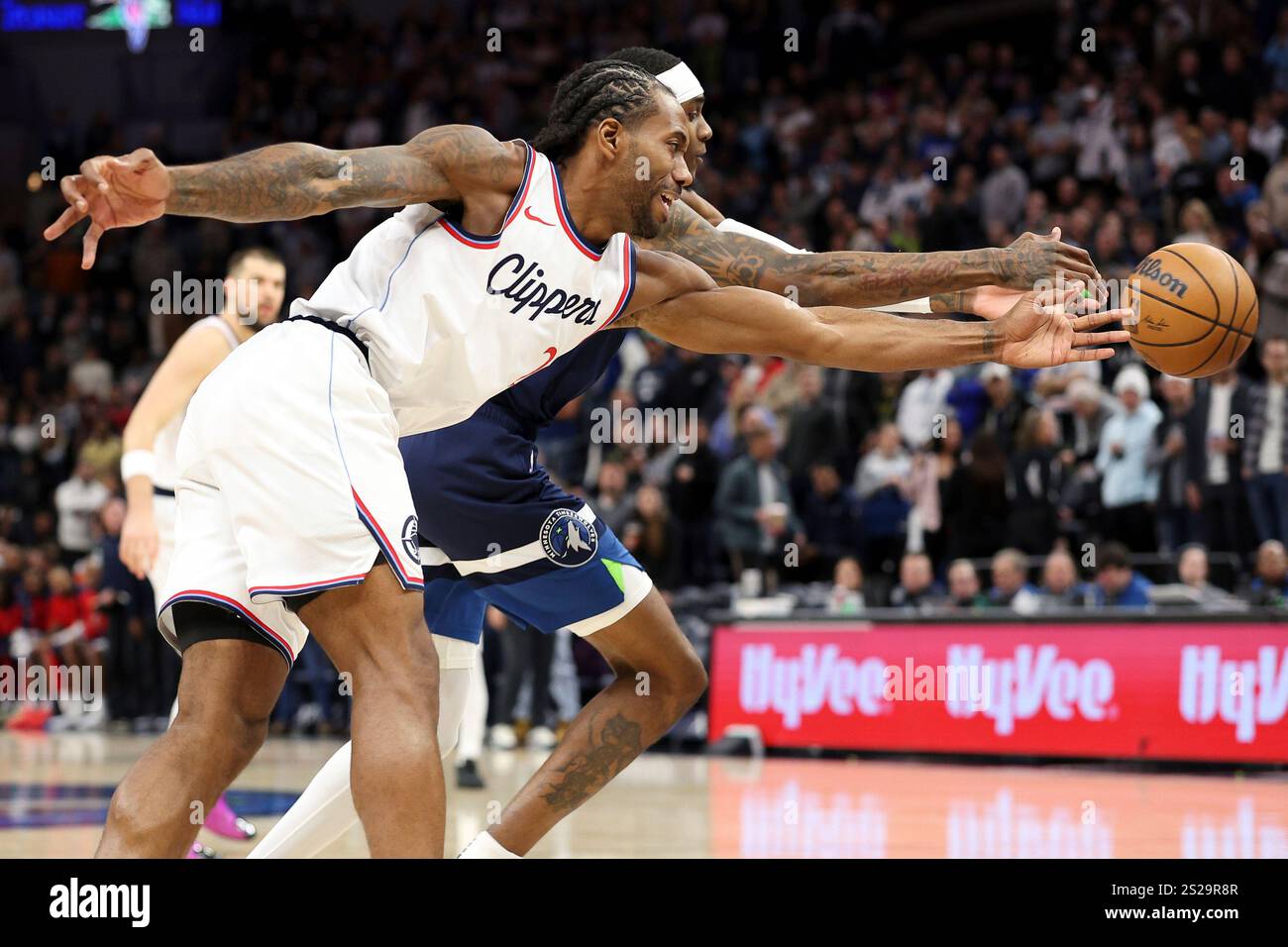 LA Clippers forward Kawhi Leonard, left, and Minnesota Timberwolves ...