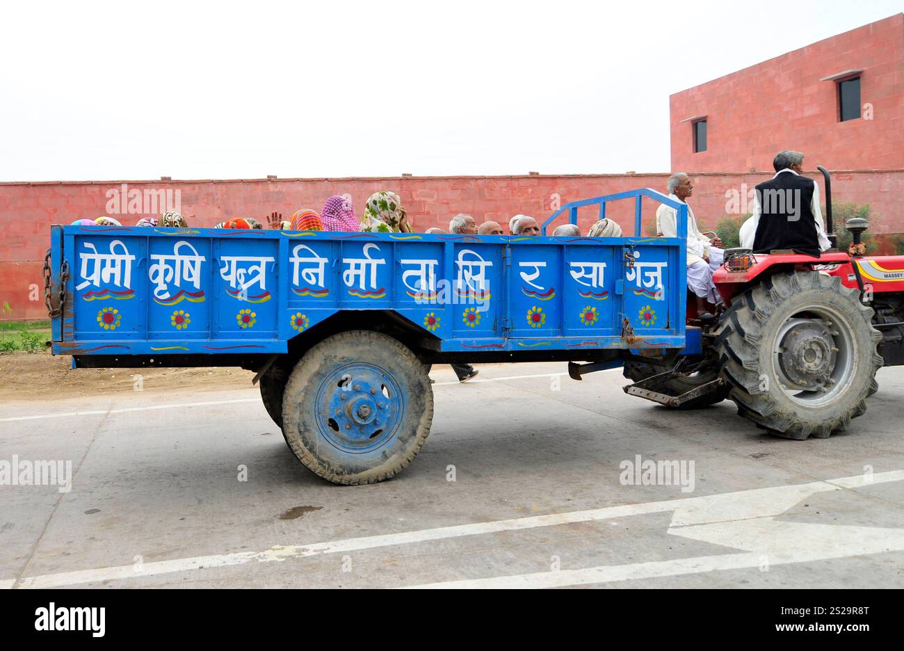 A tractor transporting passengers on a wagon. Fatehpur Sikri, India ...