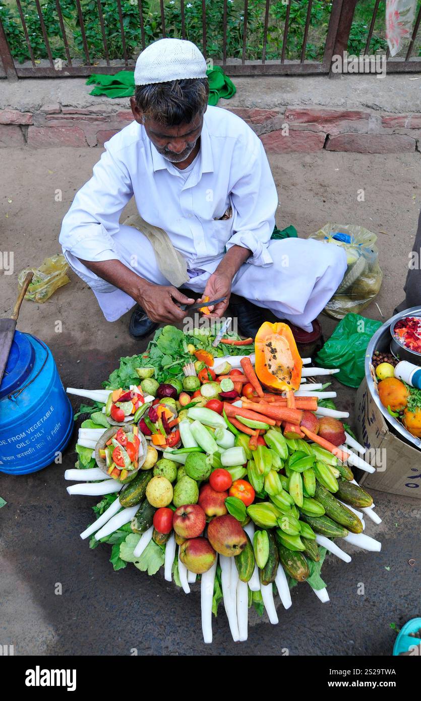 A snack vendor selling his snacks outside the Buland Darwaza gate in ...