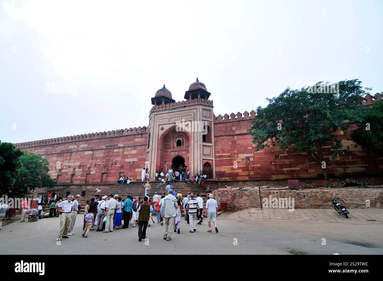 Tourist climbing the stairs leading to Buland Darwaza gate in Fatehpur ...