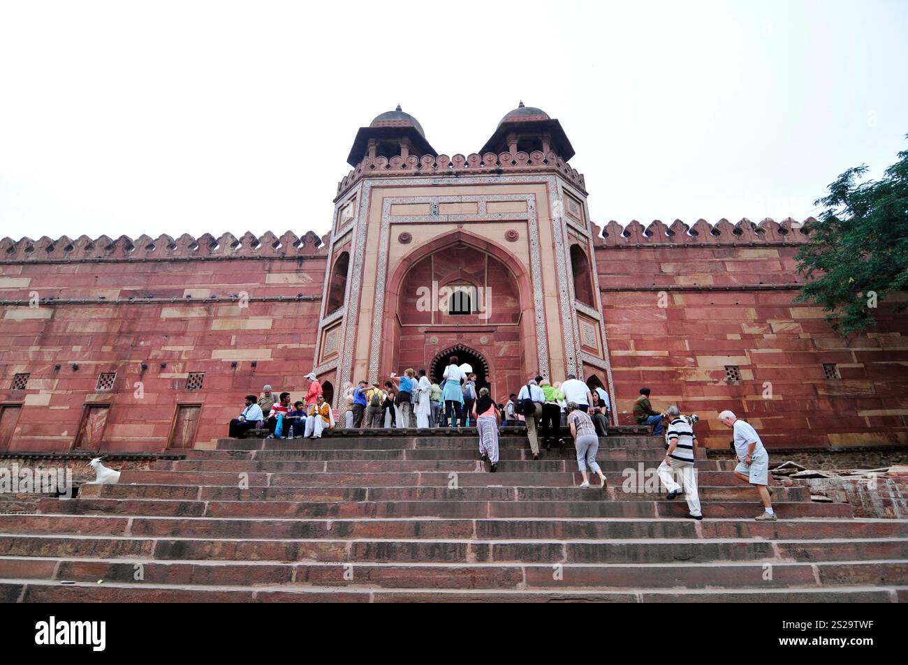 Tourist climbing the stairs leading to Buland Darwaza gate in Fatehpur ...