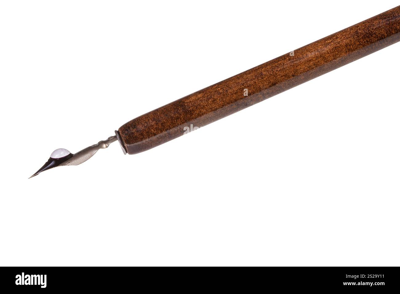 side view of ink bubble over nib of brown dip pen close up isolated on ...