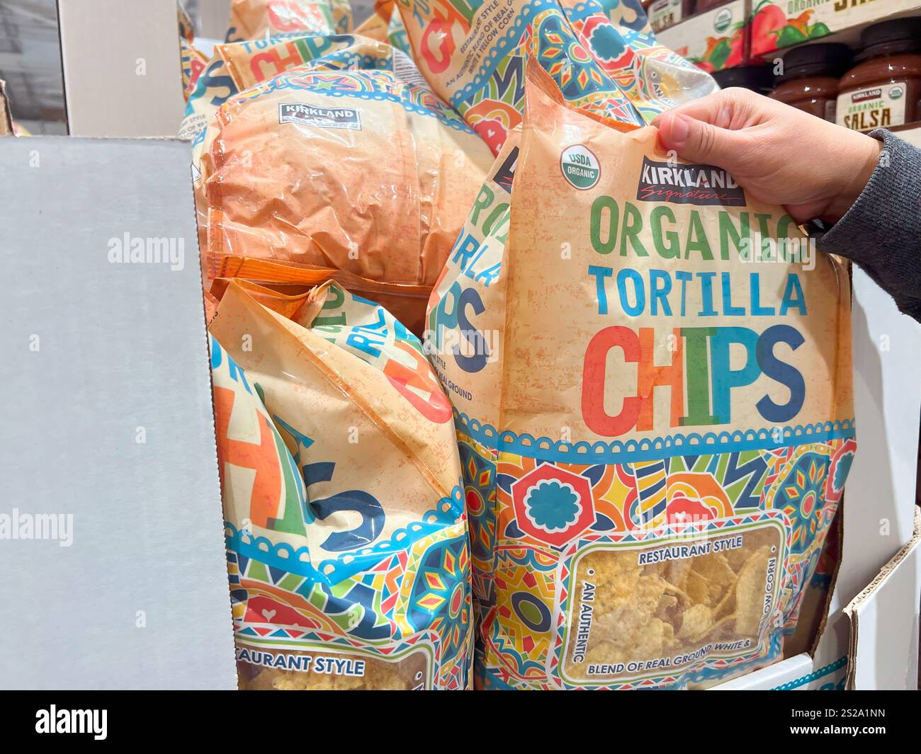 Hand grabbing Kirkland Organic Tortilla Chips in Costco Stock Photo - Alamy