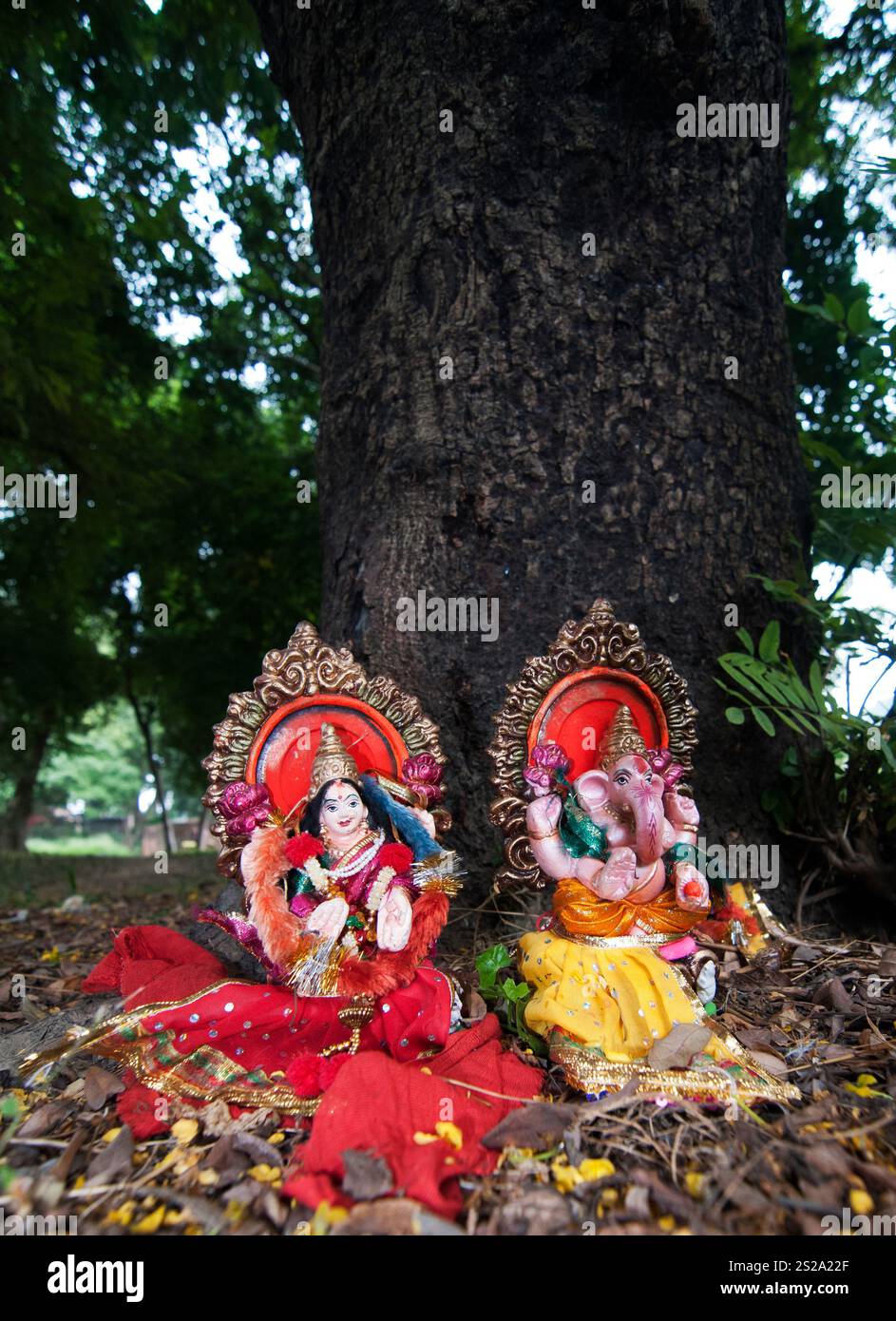 Ganesha and Parvati statues in a small temple by an old tree in The ...