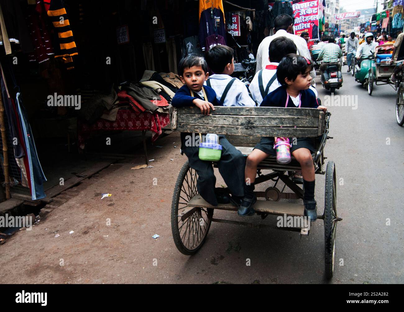 Primary school children on their way to school on a bicycle rickshaw in ...