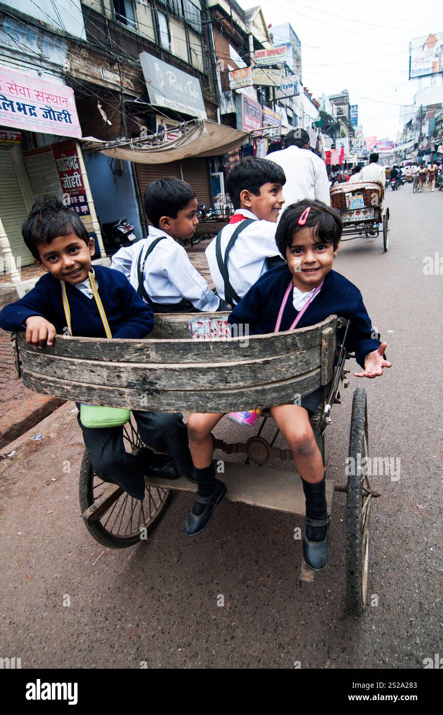 Primary school children on their way to school on a bicycle rickshaw in ...