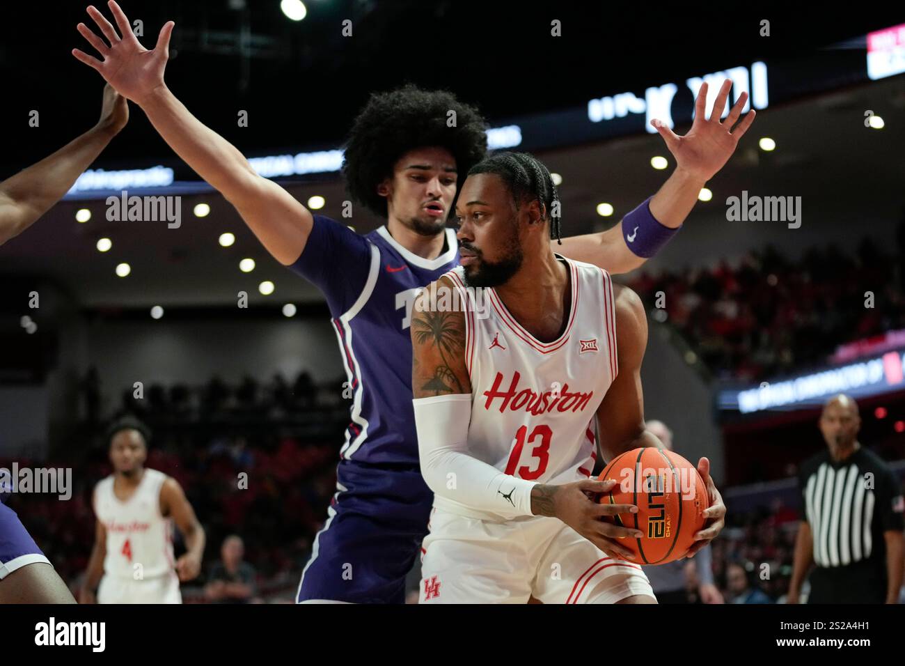 TCU forward David Punch defends against Houston forward J'Wan Roberts ...