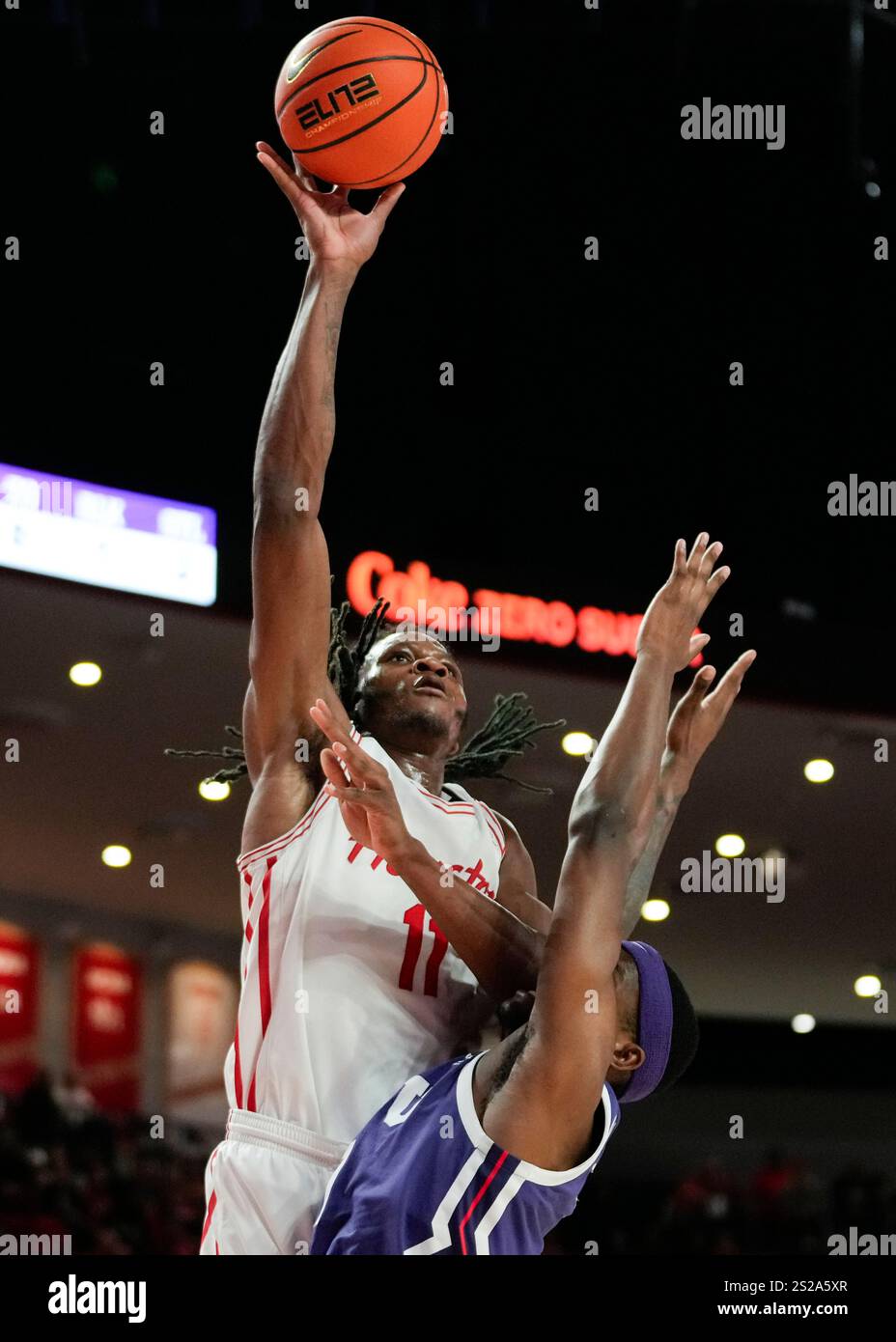 Houston forward Joseph Tugler (11) shoots against TCU forward Isaiah ...