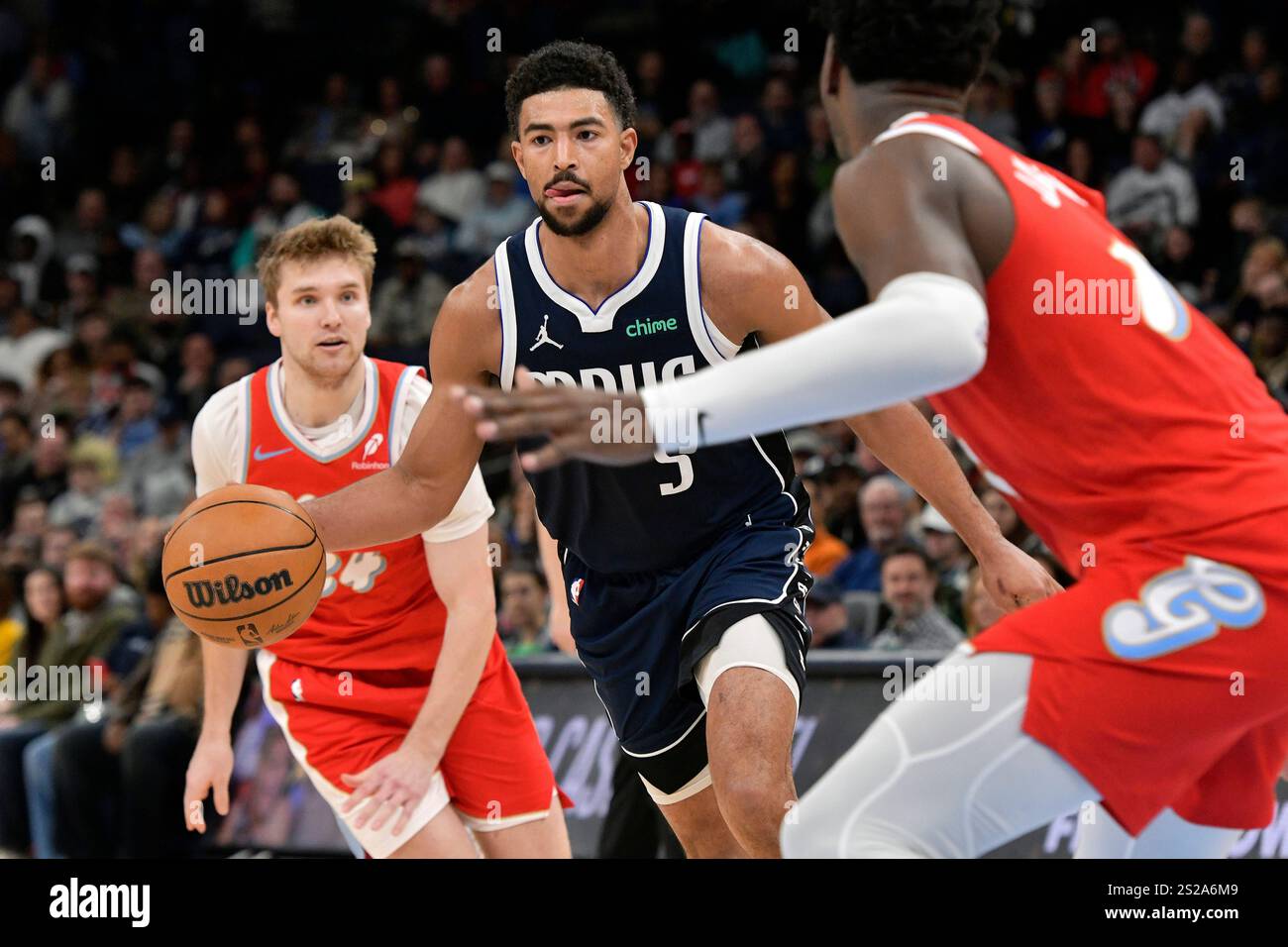 Dallas Mavericks guard Quentin Grimes, center, handles the ball between ...