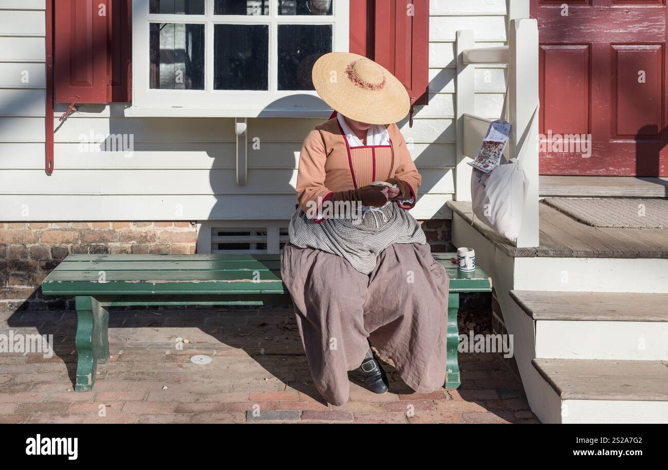 Williamsburg, VA USA - December 18, 2017: Women in period dress sits on ...